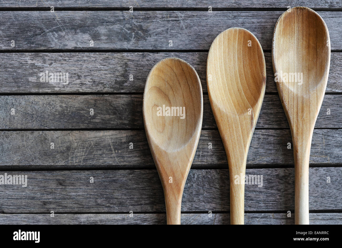 three wooden spoons on rustic wooden plank background Stock Photo - Alamy