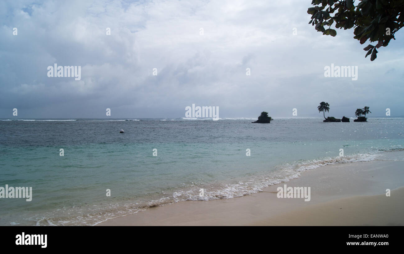 A beach with clear blue water and small islands Stock Photo - Alamy