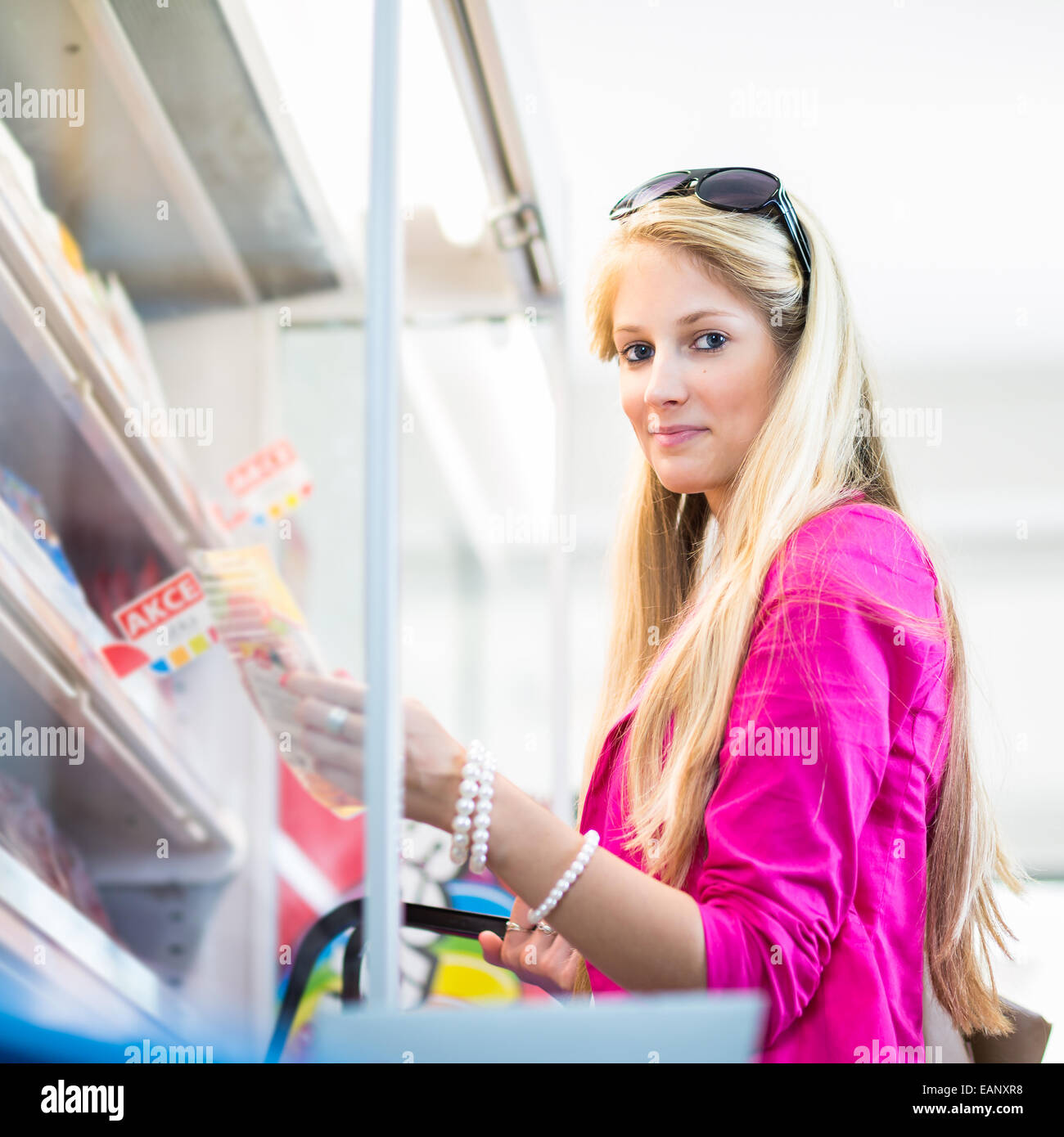 Beautiful young woman shopping in a grocery store/supermarket (color ...