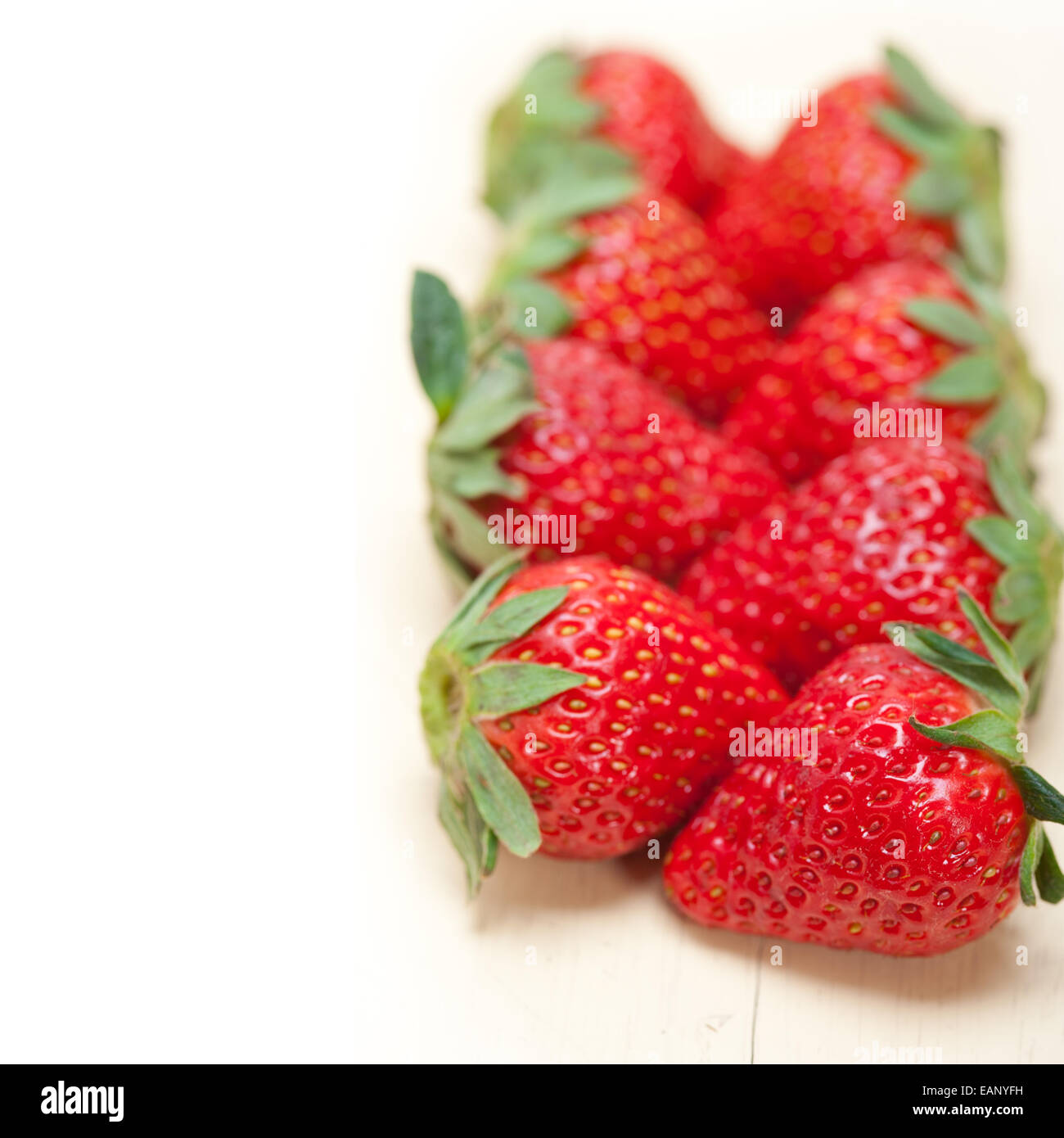 fresh organic strawberry over white rustic wood table Stock Photo - Alamy