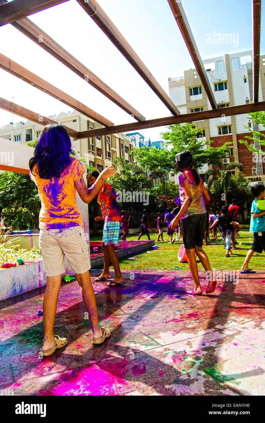 Teenage girls having fun playing with colored powders on a hindu ...