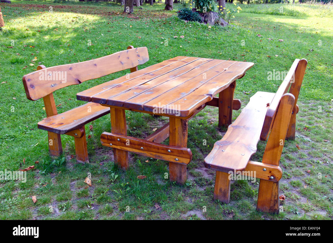 wooden table and seats in summer time picnic park Stock Photo - Alamy
