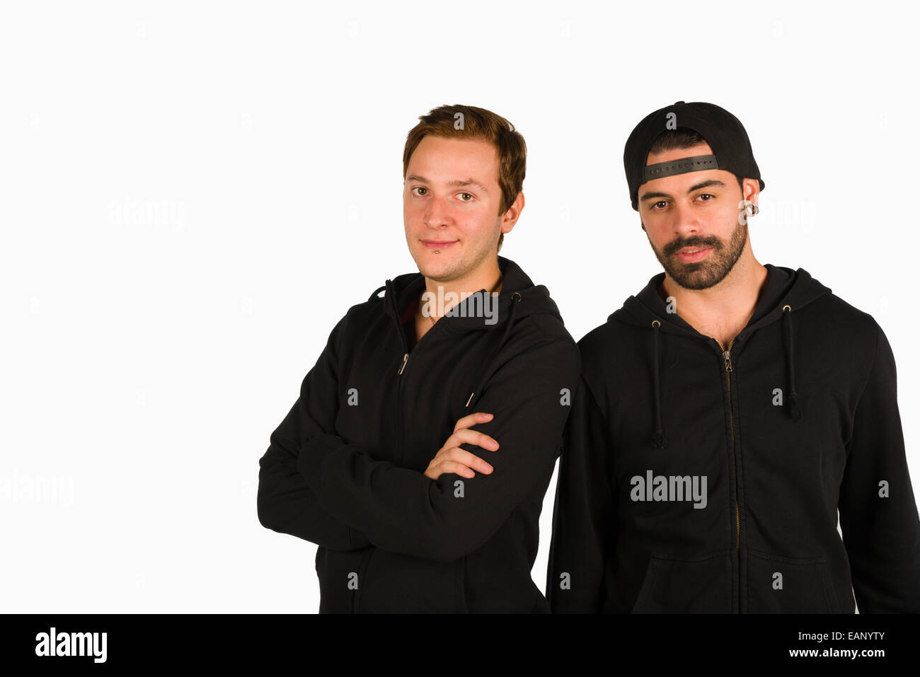 Studio portrait of two cool, self confident guys in their 20s Stock ...