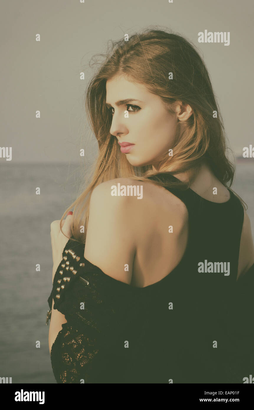 Woman looking over shoulder unhappy hi-res stock photography and images ...