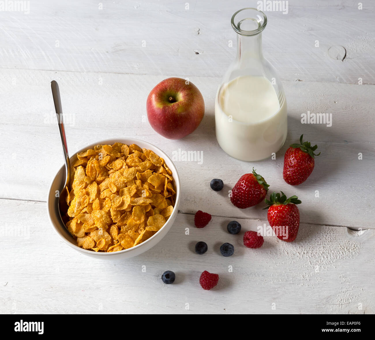 Cornflakes in a bowl with milk and fruits Stock Photo - Alamy