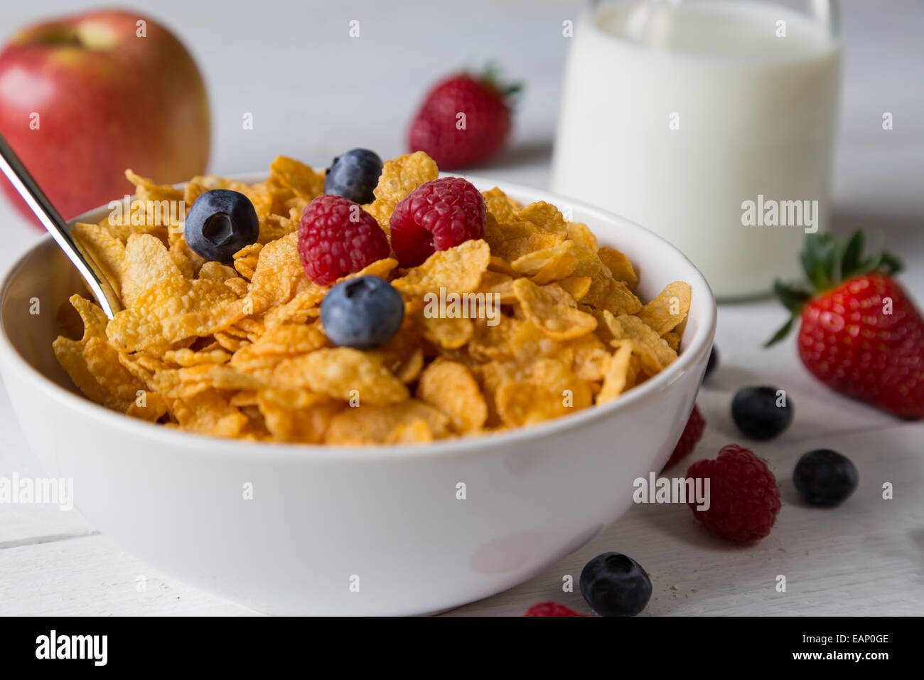 Cornflakes in a bowl with milk and fruits Stock Photo - Alamy