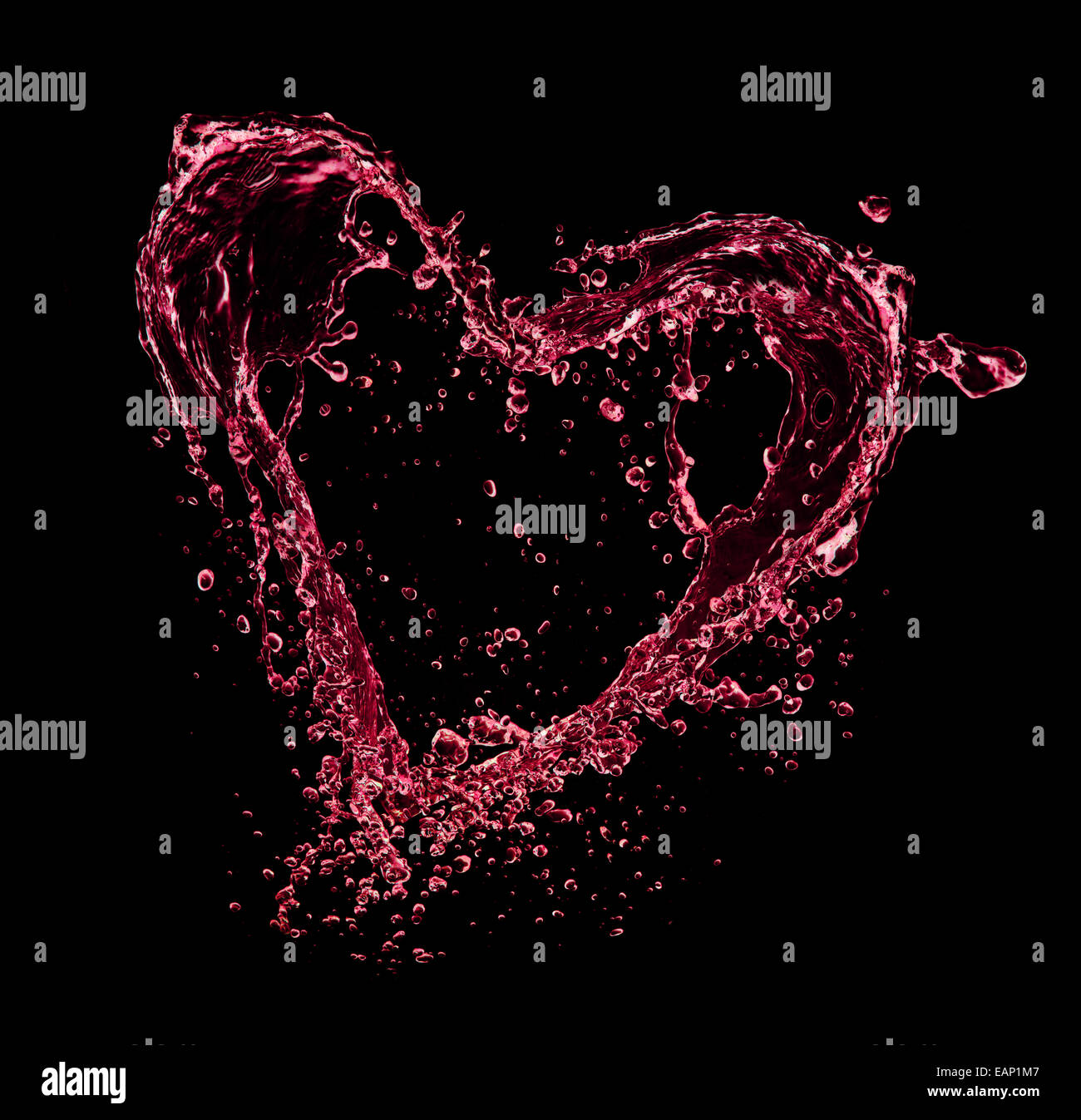 Heart symbol made of liquid splashes, isolated on black background ...