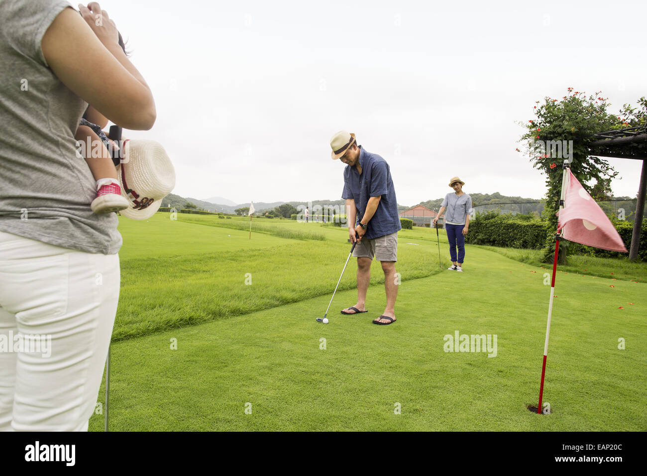 Family on a golf course Stock Photo - Alamy