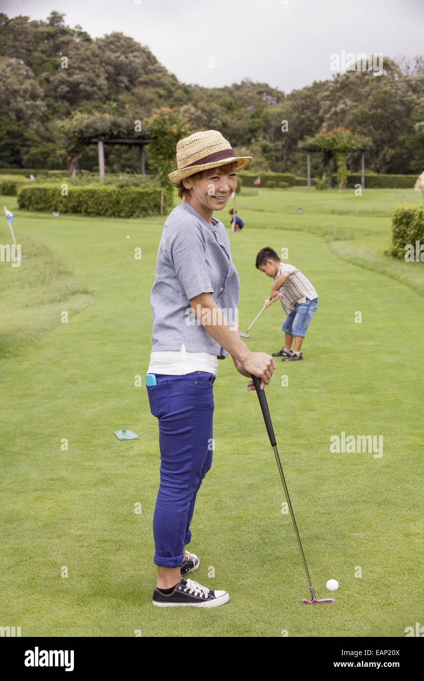 Family on a golf course Stock Photo - Alamy