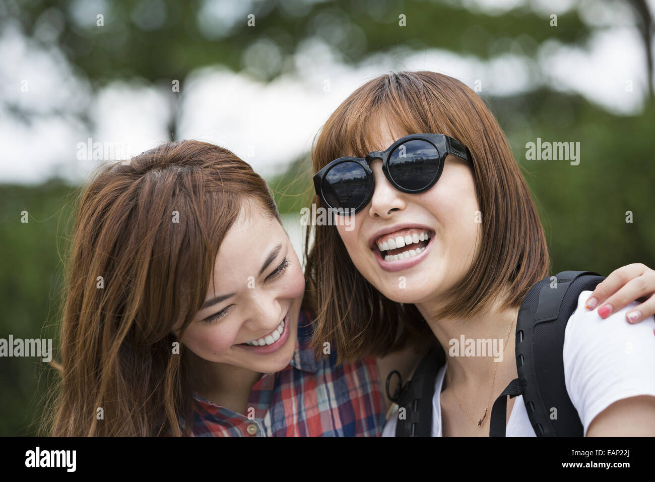 Two young women in the park Stock Photo - Alamy