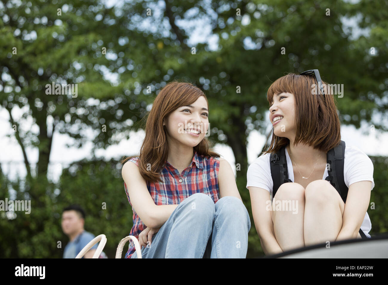 Two young women in the park Stock Photo - Alamy