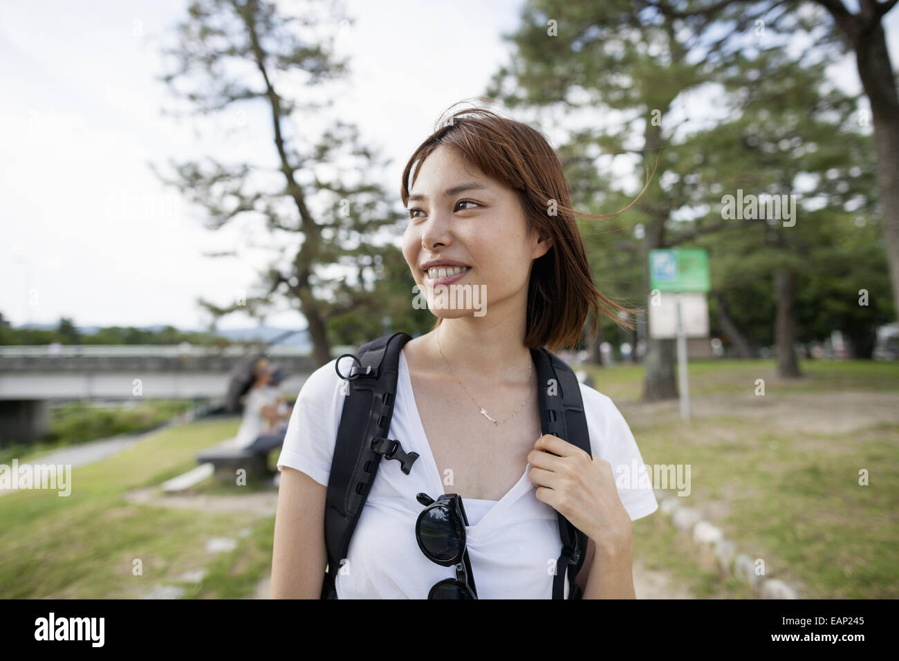 Young woman in the park carrying a rucksack Stock Photo - Alamy