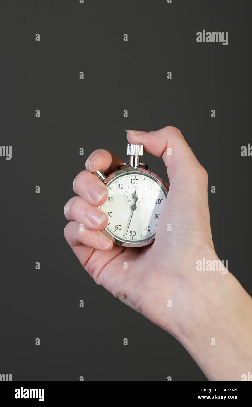 Woman's hand holding a stopwatch Stock Photo - Alamy