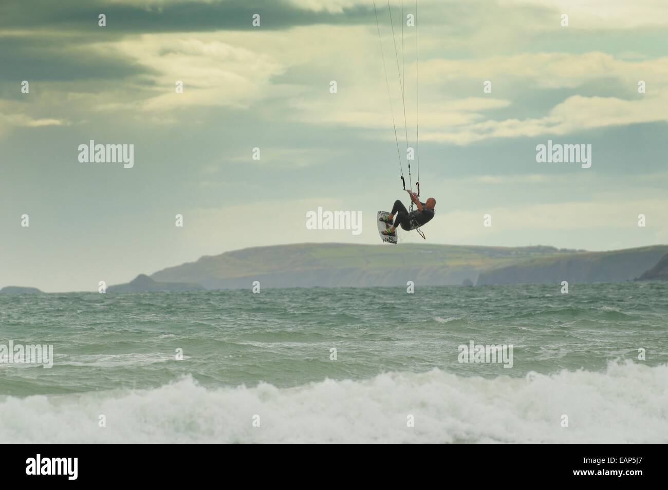 A spectacular jump off a wave when kiteboarding in ideal conditions at ...