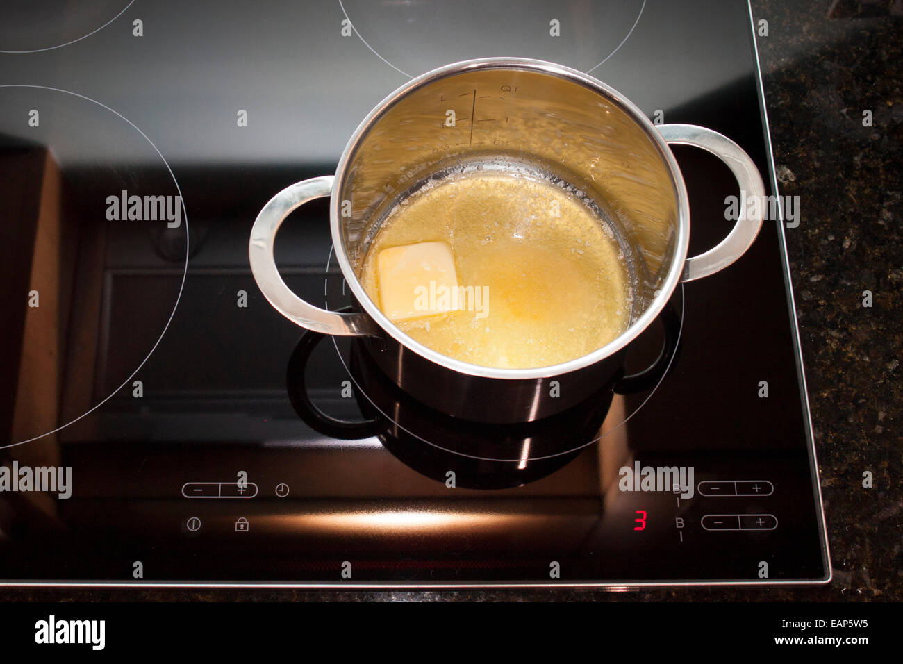 Butter melting in a pan Stock Photo - Alamy
