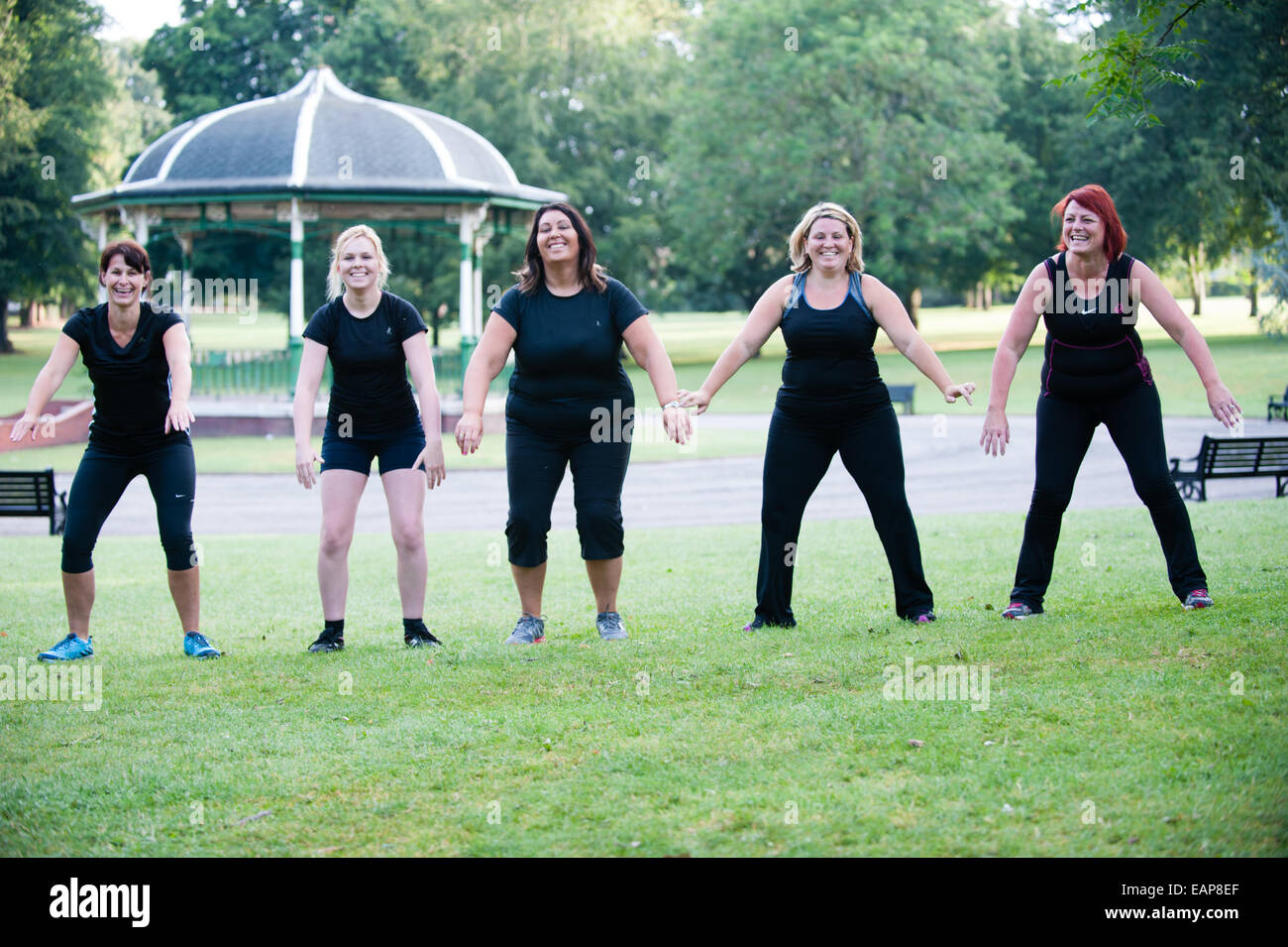 Five white overweight women in gym clothese having fun at a boot camp ...