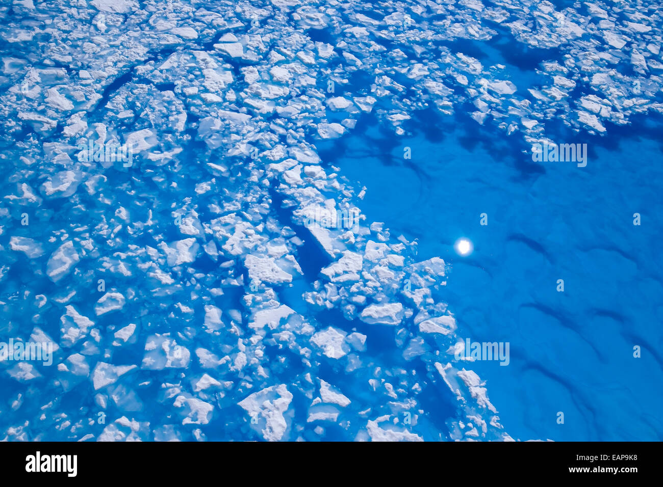 Breaking Surface Ice Reveals The Brilliant Blue Waters Of A Melt Pond ...