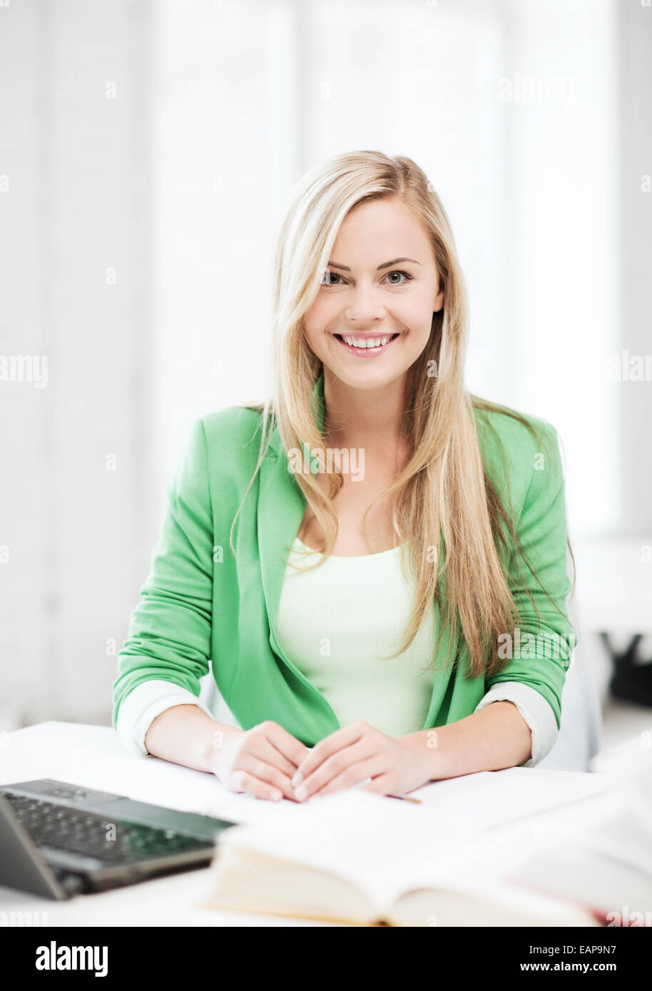 smiling student girl with laptop at school Stock Photo - Alamy