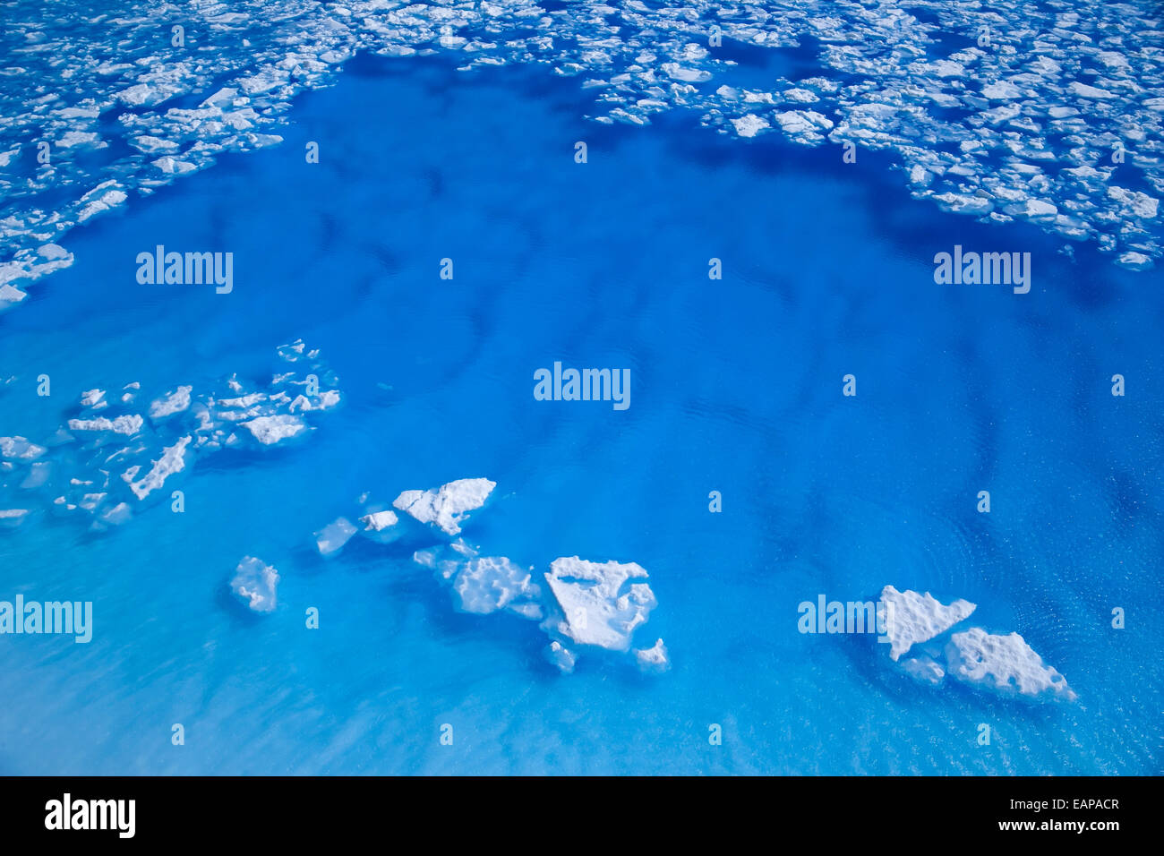 Breaking Surface Ice Reveals The Brilliant Blue Waters Of A Melt Pond ...
