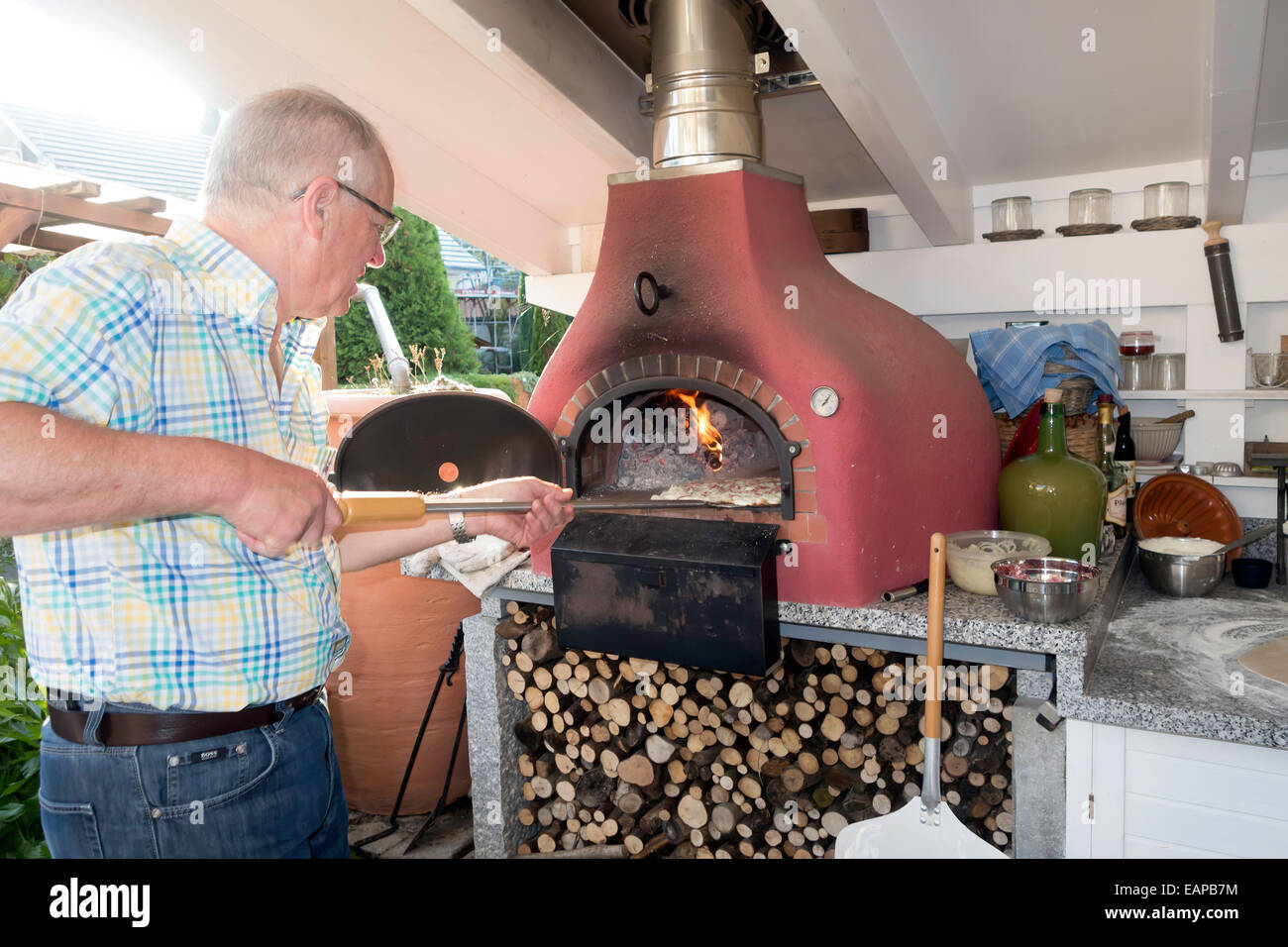 Outdoor baking of a South German tradition;Flammkuchen in a Wood ...