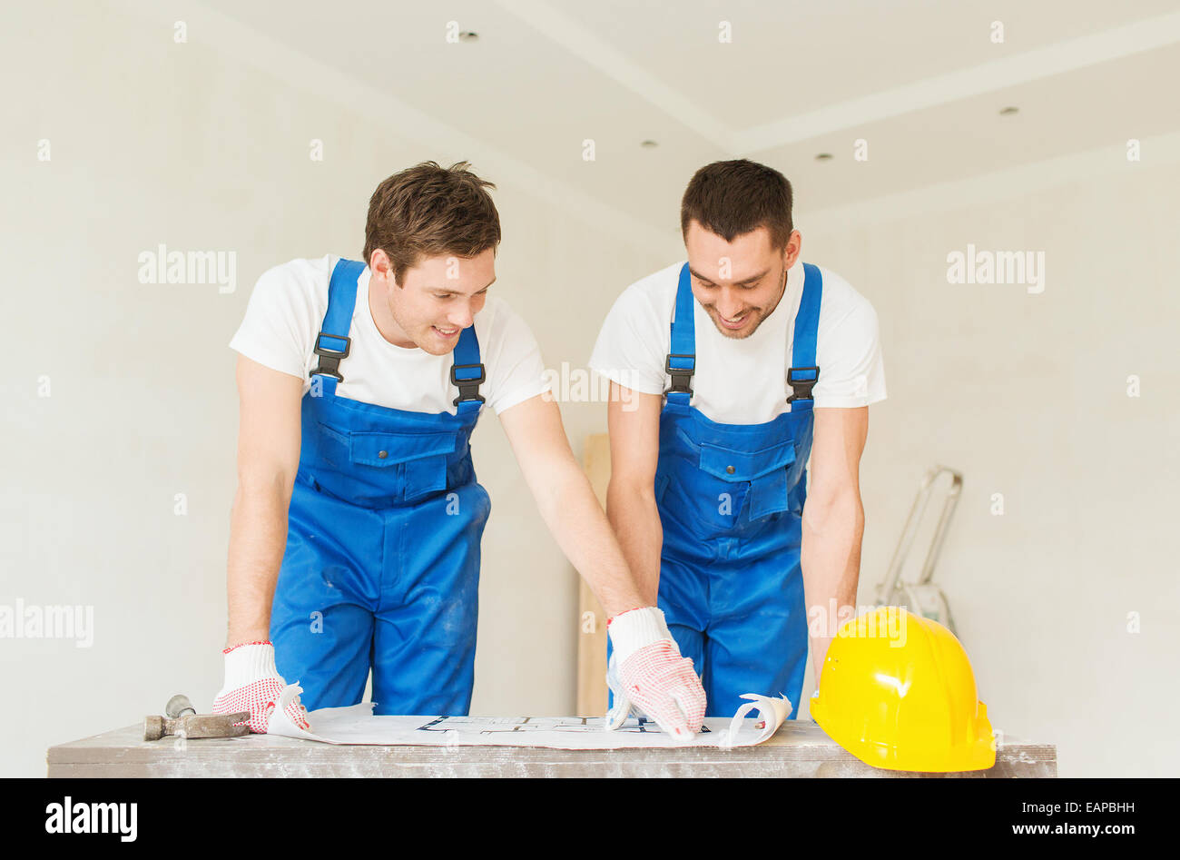 group of builders with blueprint Stock Photo - Alamy