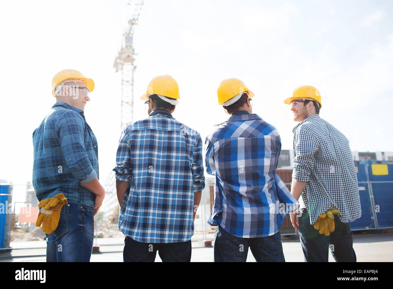 group of smiling builders in hardhats outdoors Stock Photo - Alamy
