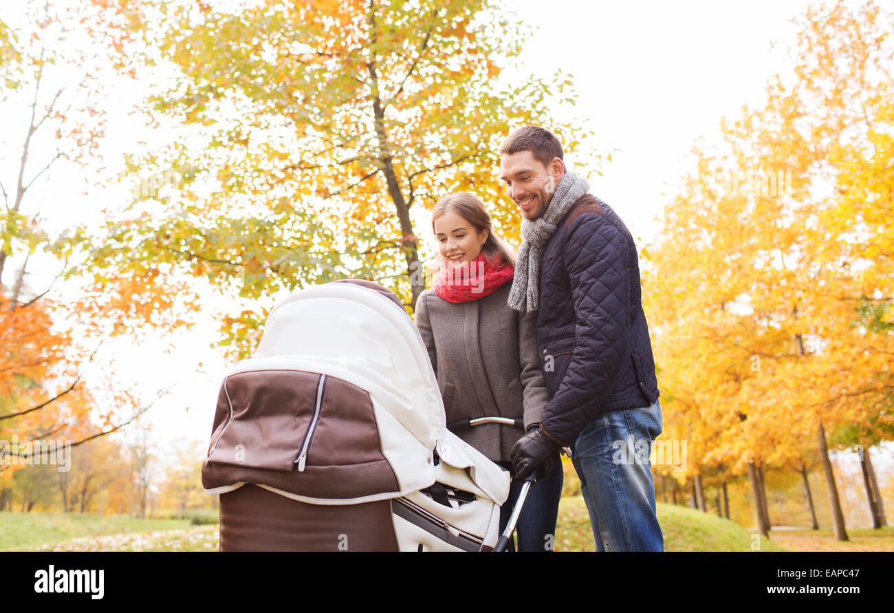 smiling couple with baby pram in autumn park Stock Photo - Alamy