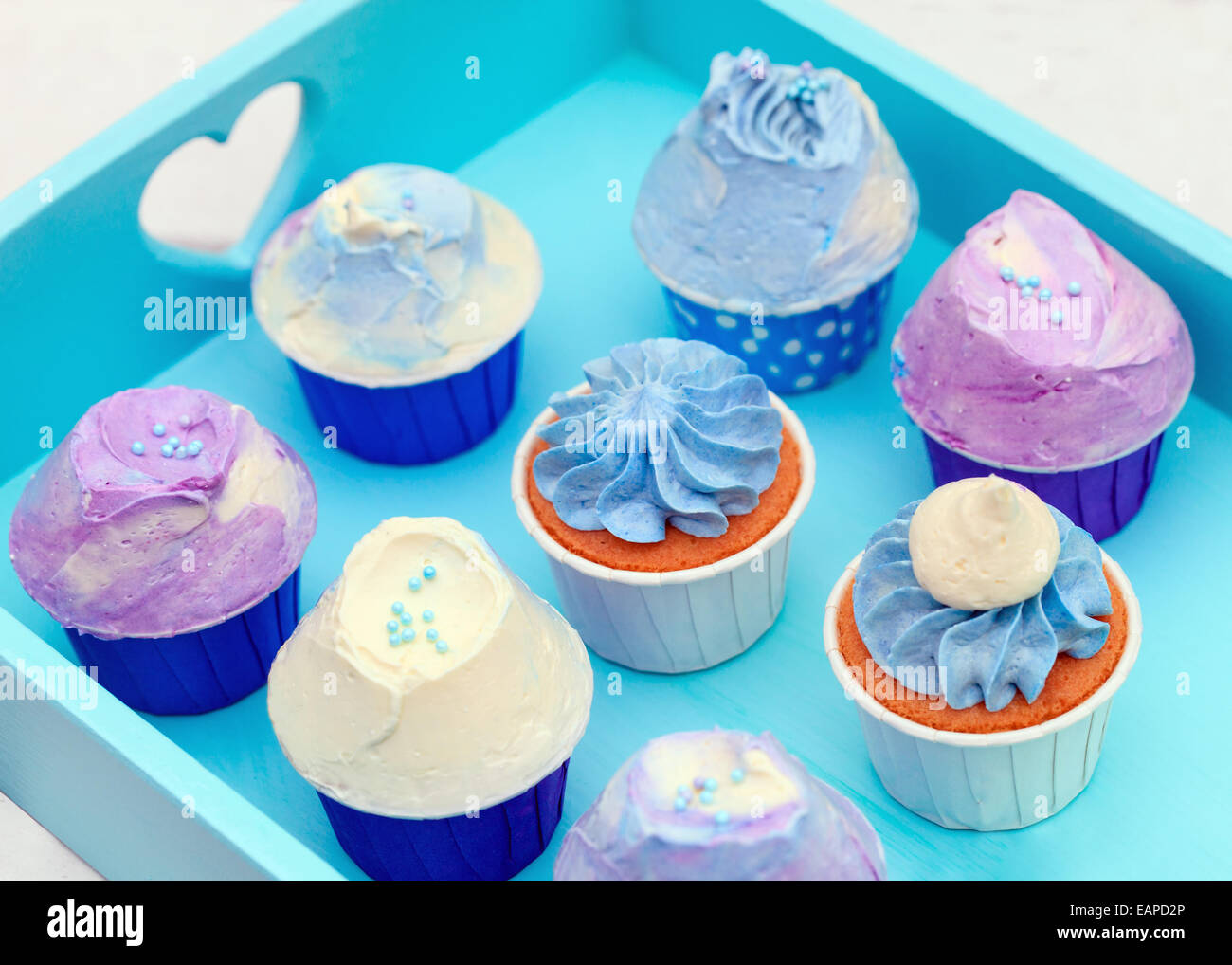 Delicious sweet buffet with cupcakes on cyan background Stock Photo - Alamy