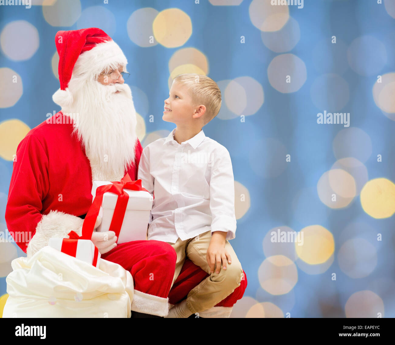 smiling little boy with santa claus and gifts Stock Photo - Alamy