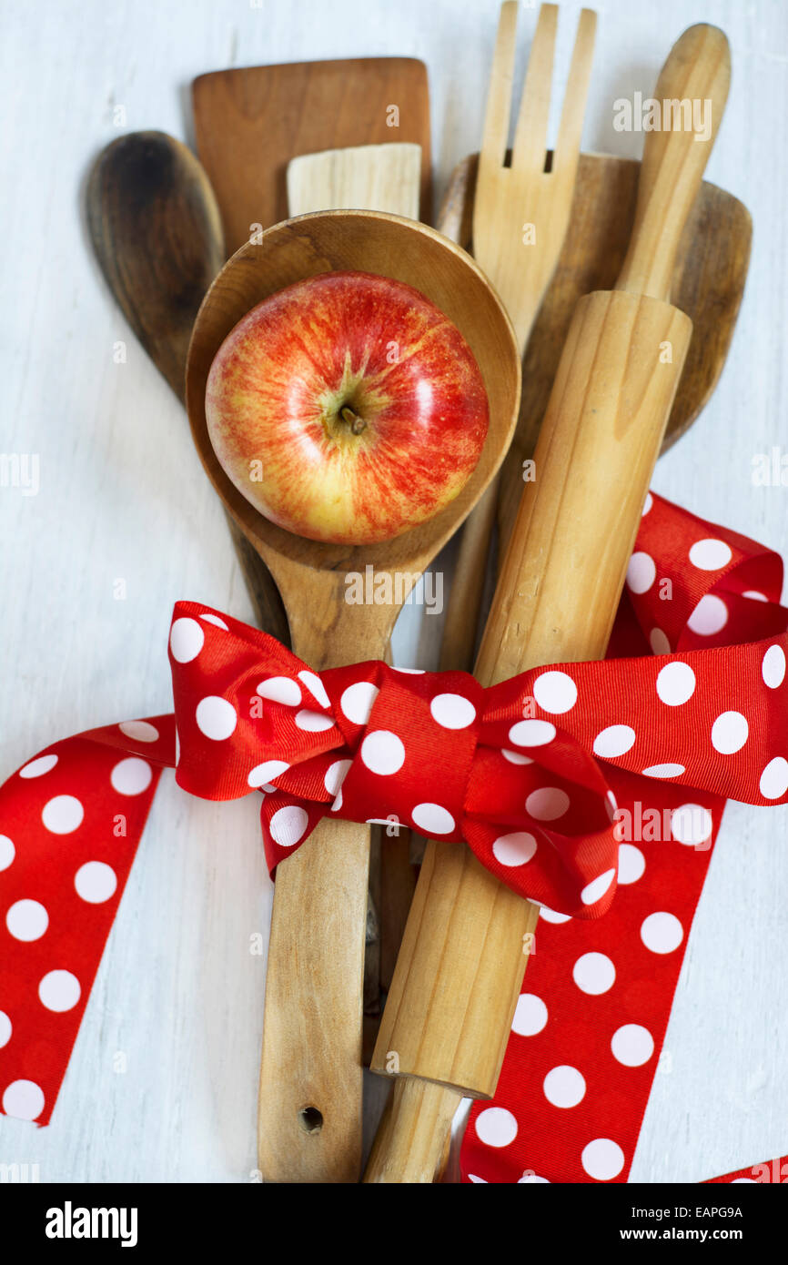 wooden spoons, connected by a red tape lunar white wood background ...
