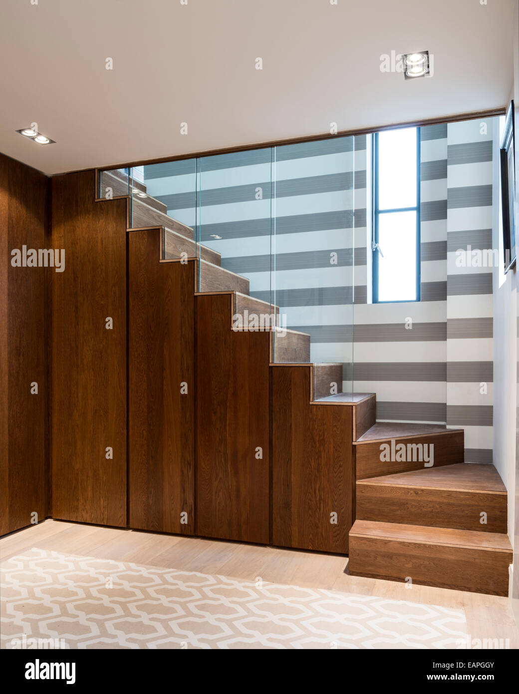 Cherrywood staircase with inbuilt cupboard storage Stock Photo - Alamy