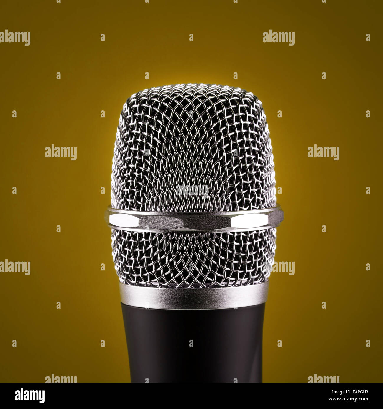 Wireless microphone closeup on yellow background Stock Photo - Alamy