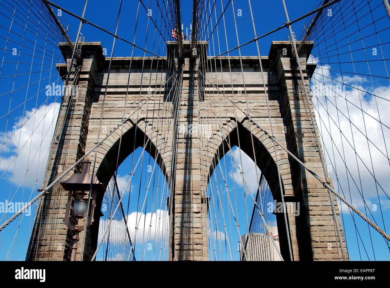 NYC: The majestic neo-gothic arched west tower and suspension cables of ...