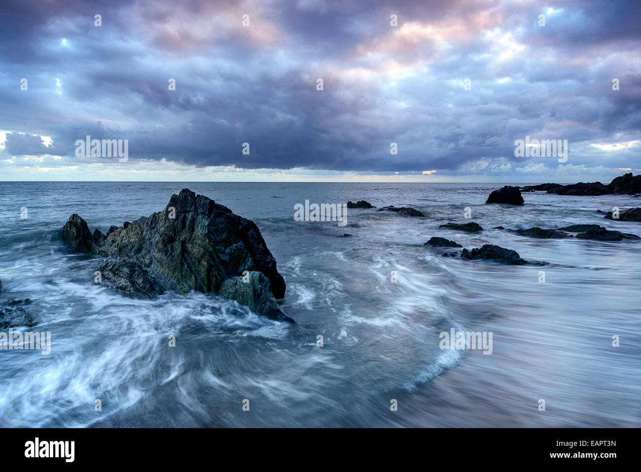 The tide flowing over rocks on the beach at Portwrinkle on the south ...