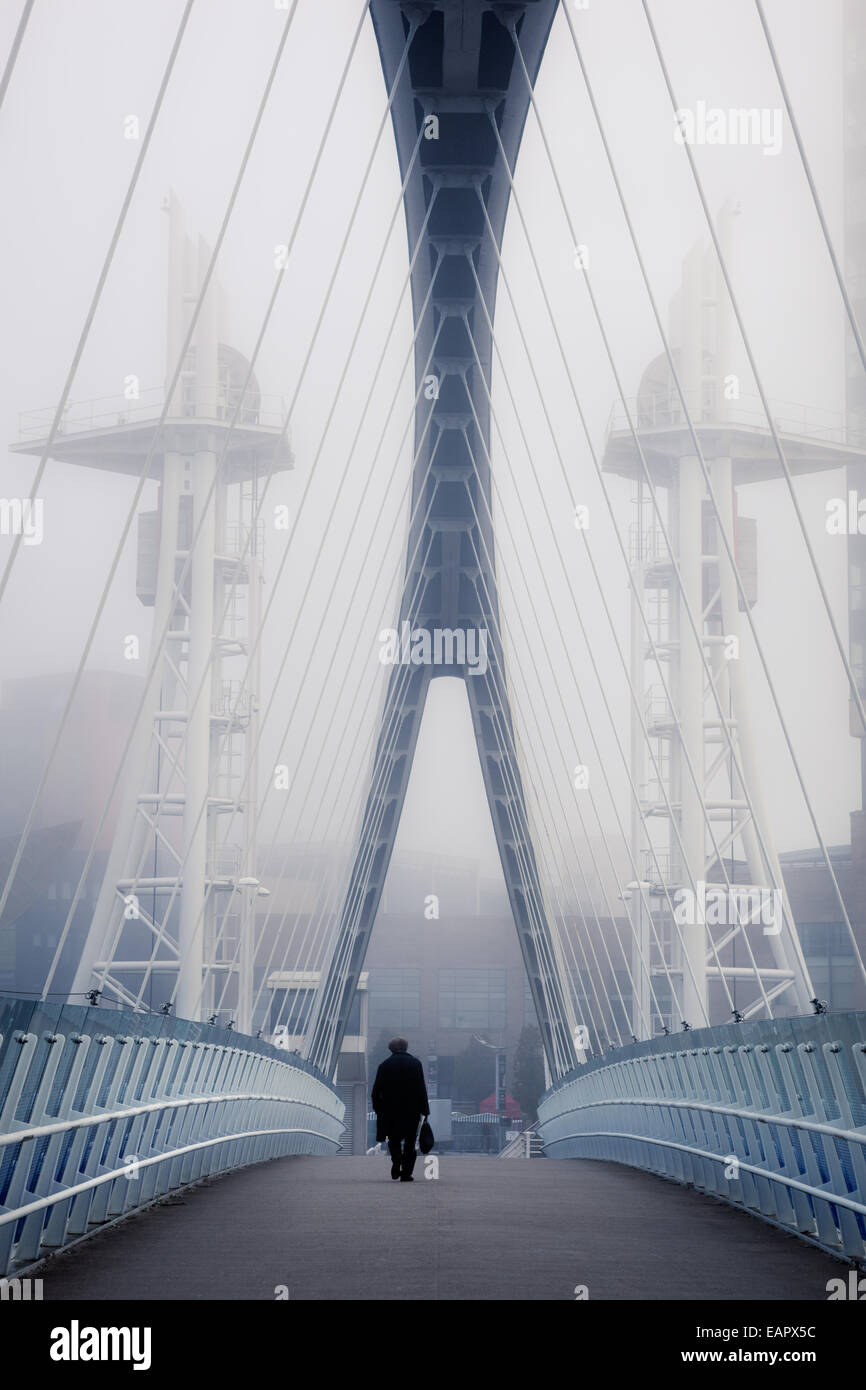 Man crossing the bridge going for a work in a foggy morning Stock Photo ...