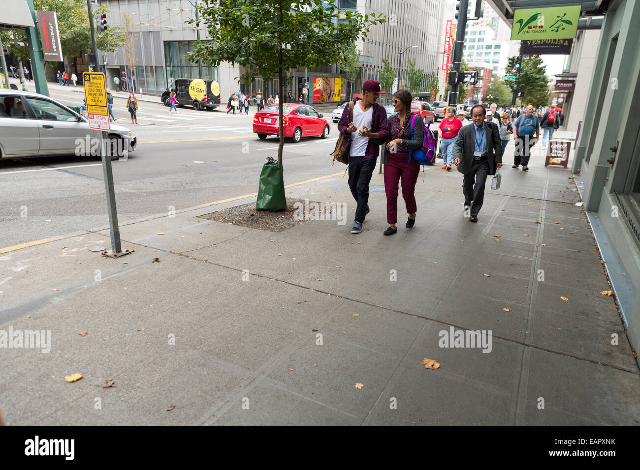 People walking on a sidewalk Stock Photo - Alamy