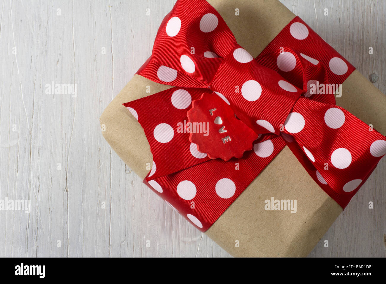 gift box handmade dotted red tape and label, wrapped in brown paper ...