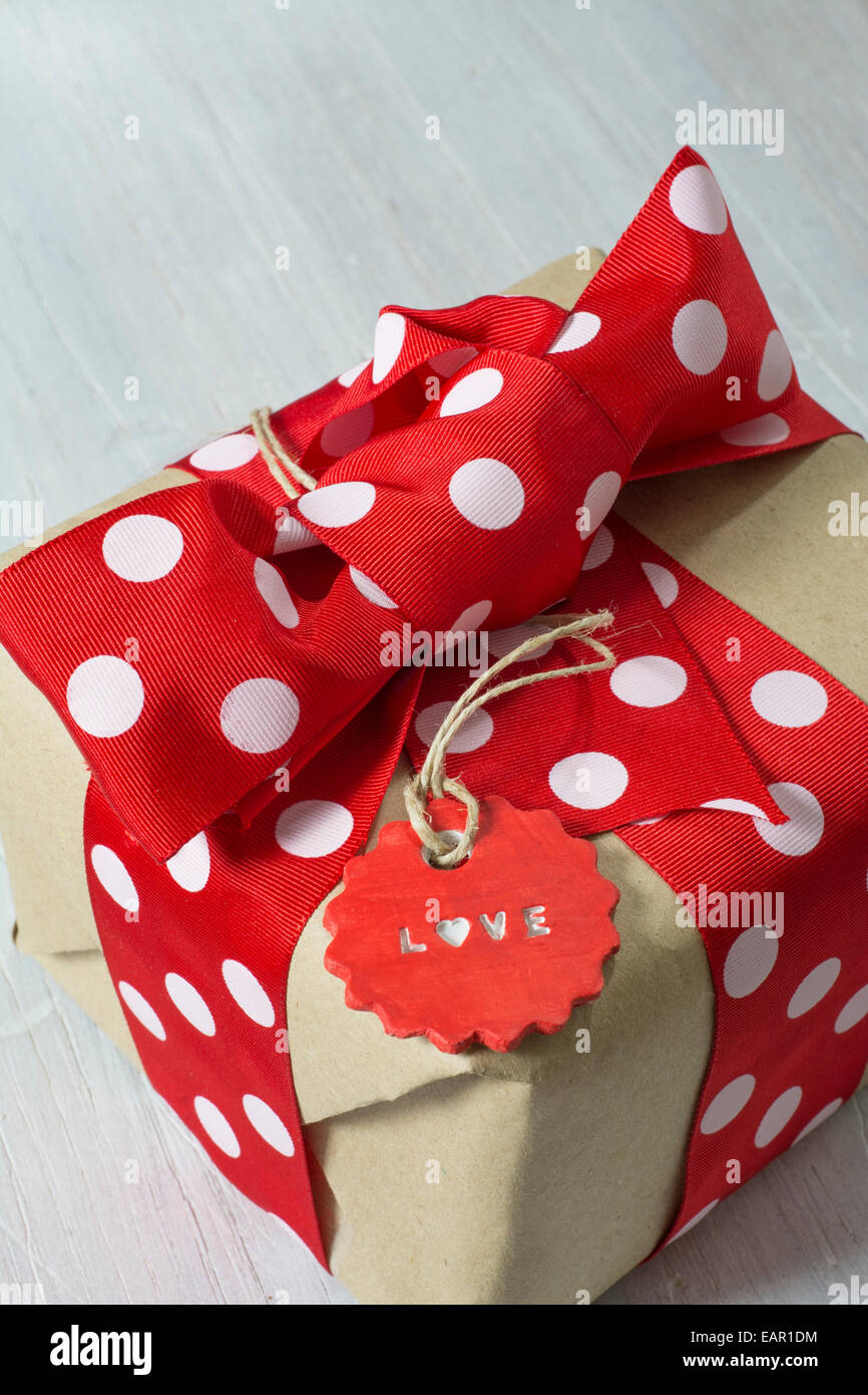 gift box handmade dotted red tape and label, wrapped in brown paper ...
