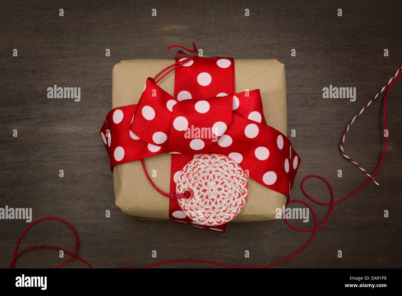 gift box handmade dotted red tape and label, wrapped in brown paper ...