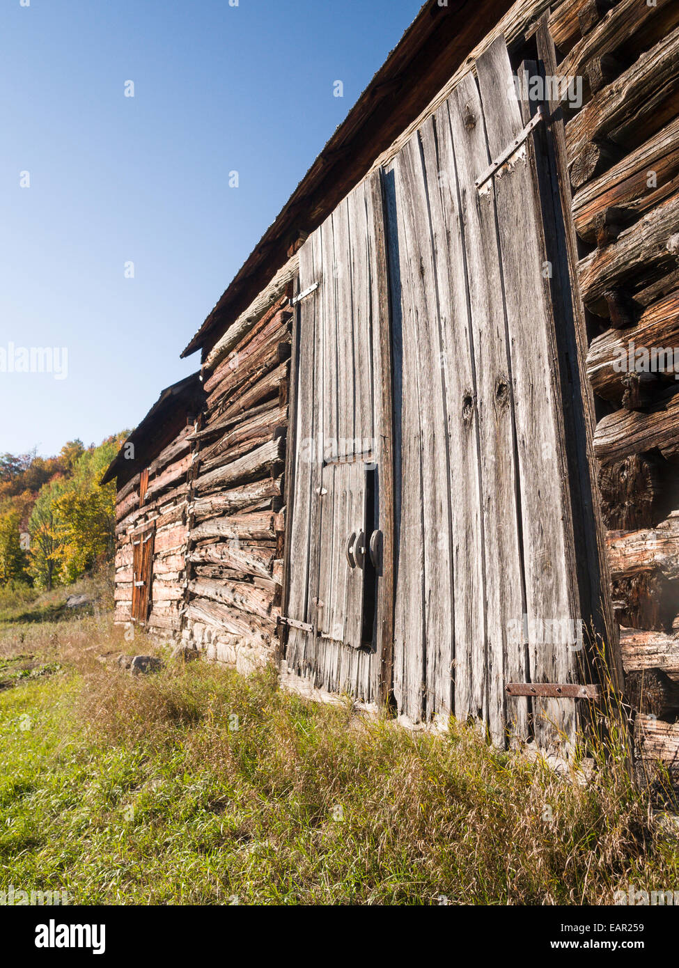 Log Barns with massive door. Two 19th century log barns lit by the ...