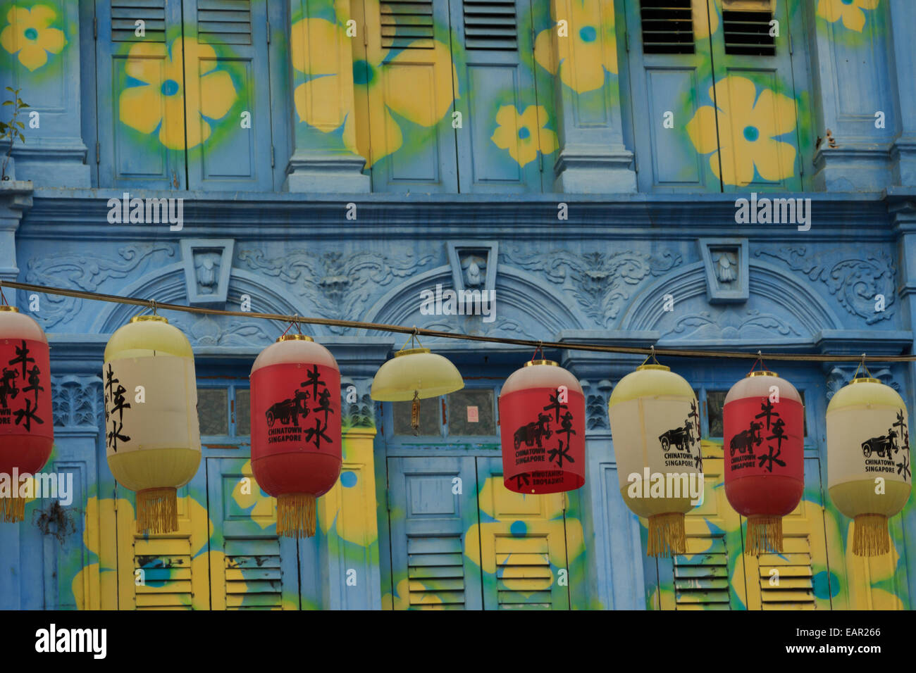 A photograph of a colorful shop front with some hanging lanterns in ...