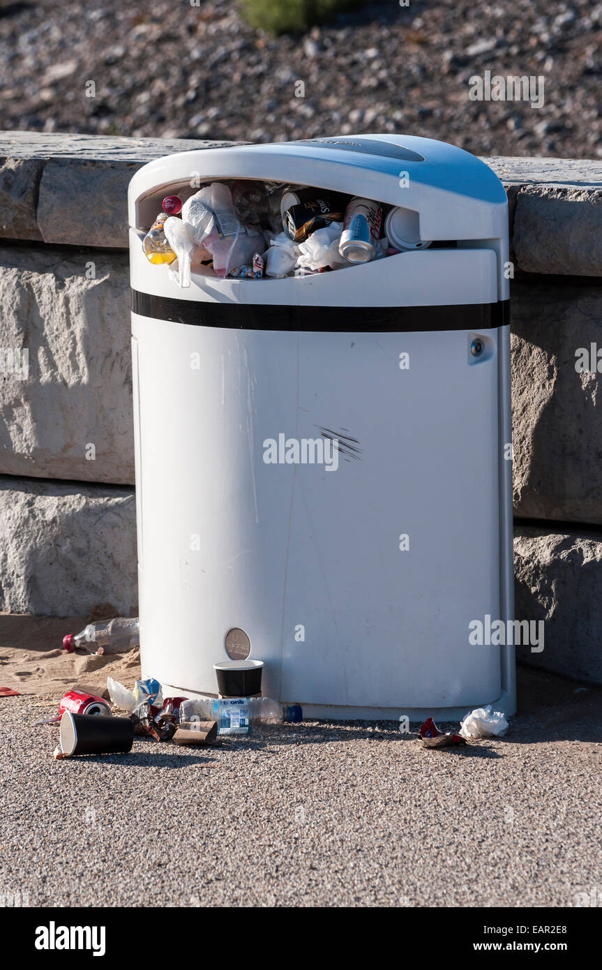 Overflowing waste bin near Pont y Ddraig cycle bridge Rhyl North Wales ...