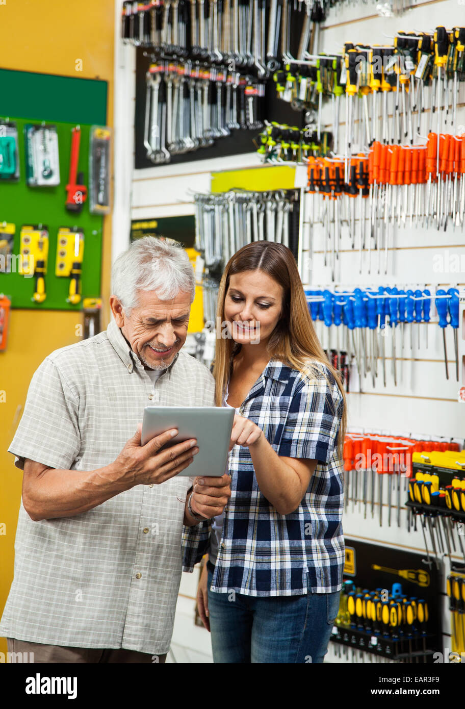 Family Using Tablet Computer In Hardware Store Stock Photo - Alamy