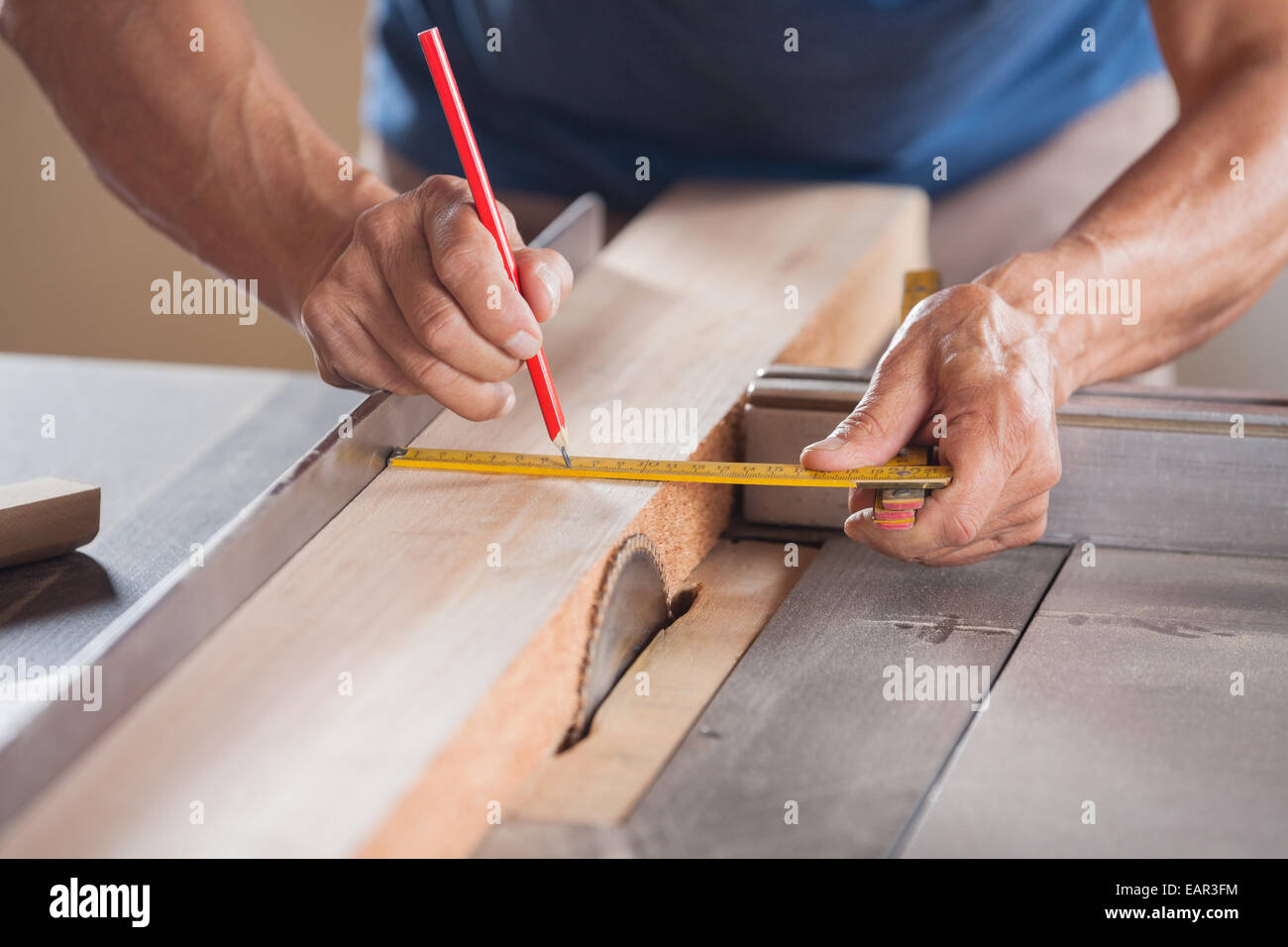 Cropped Image Of Carpenter Measuring Wood At Tablesaw Stock Photo - Alamy