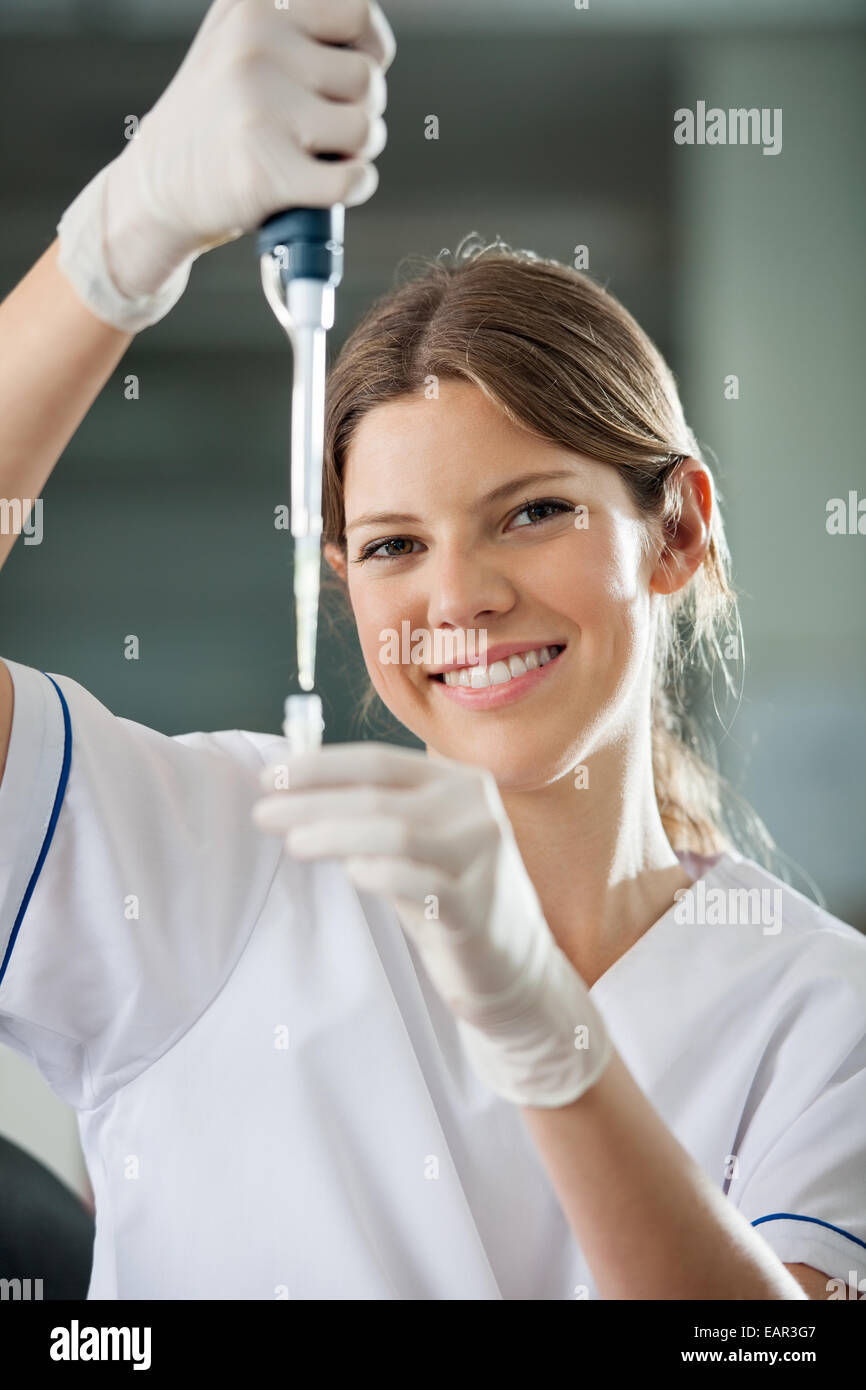 Female Scientist Filling Liquid Into Test Tube Stock Photo - Alamy