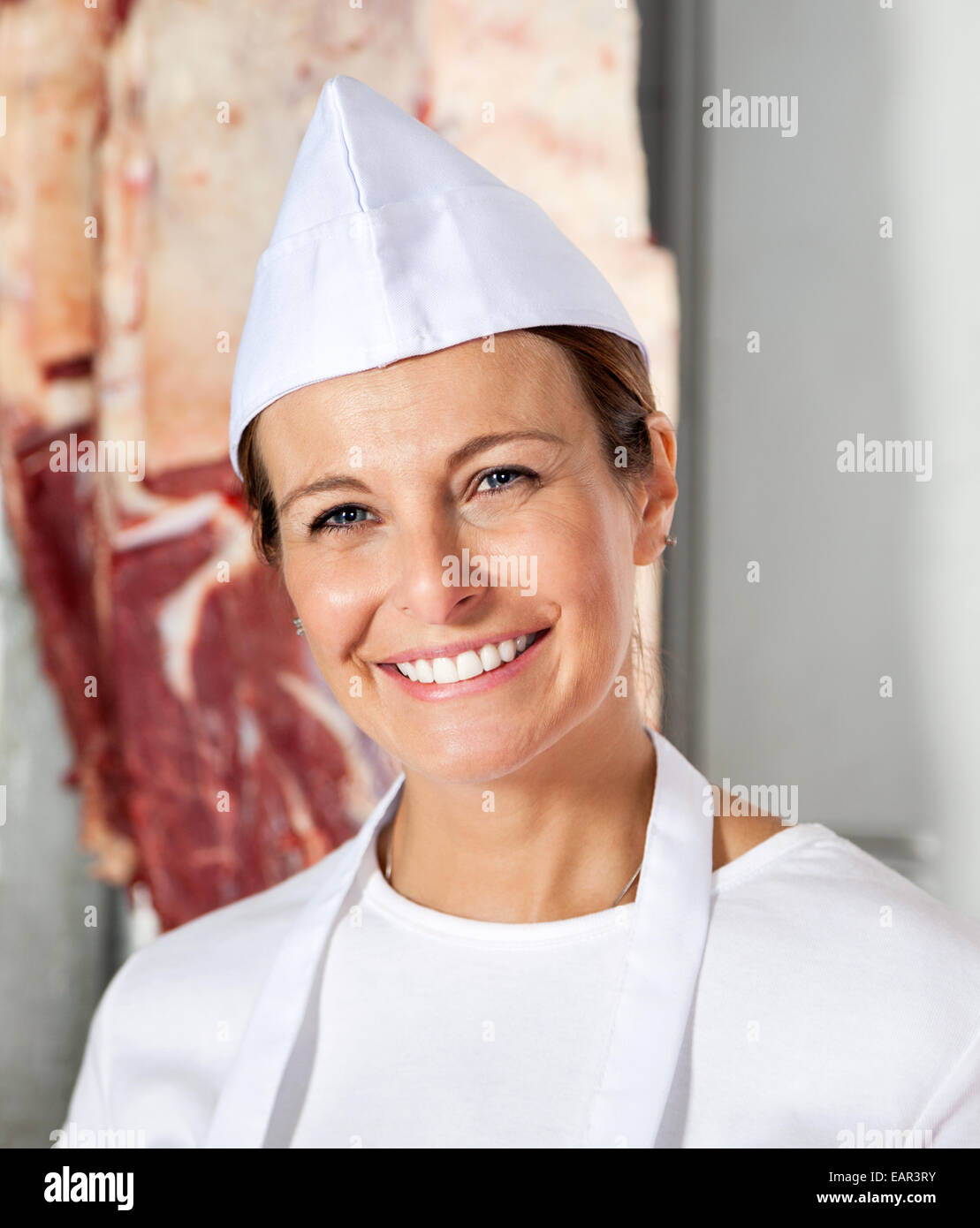 Confident Female Butcher Smiling In Shop Stock Photo - Alamy