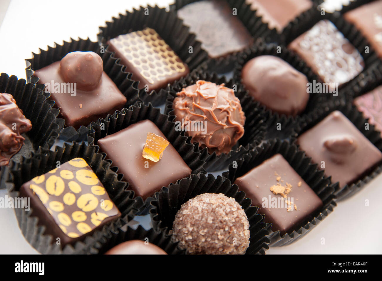 delicious chocolate pralines on white background Stock Photo - Alamy