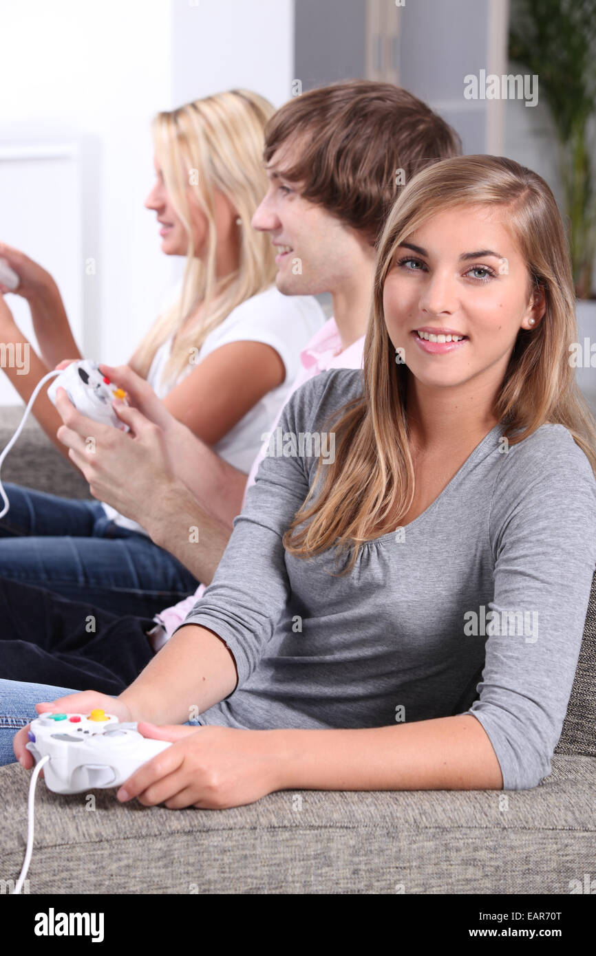 trio playing video games Stock Photo - Alamy