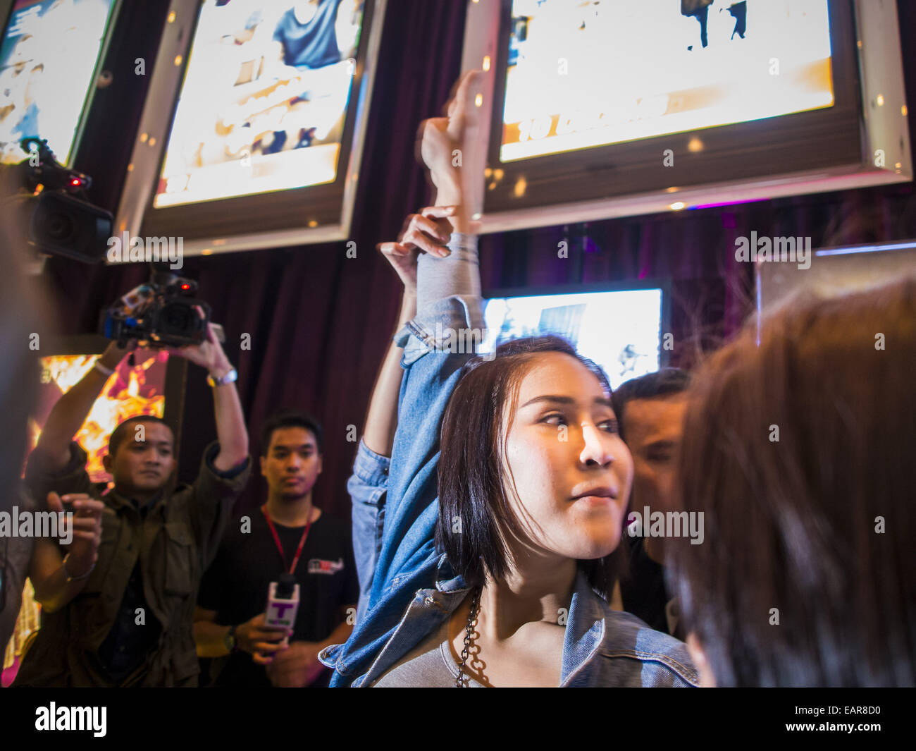 Bangkok, Thailand. 20th Nov, 2014. A Thai police officers reaches for NATCHACAH KONG-UDOM while ...