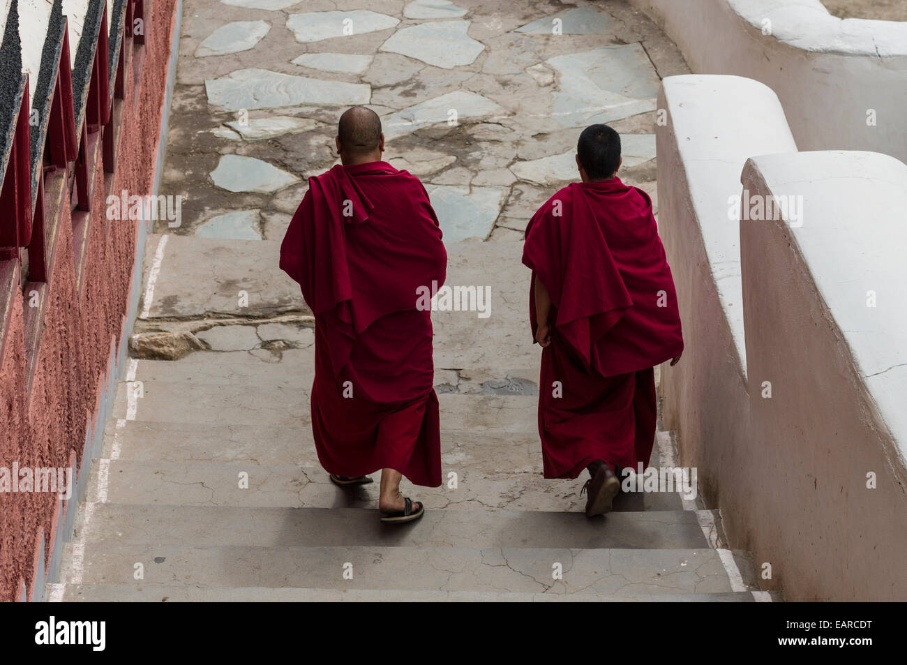 Two monks walking down some stairs in Thiksey Gompa monastery, Ladakh ...